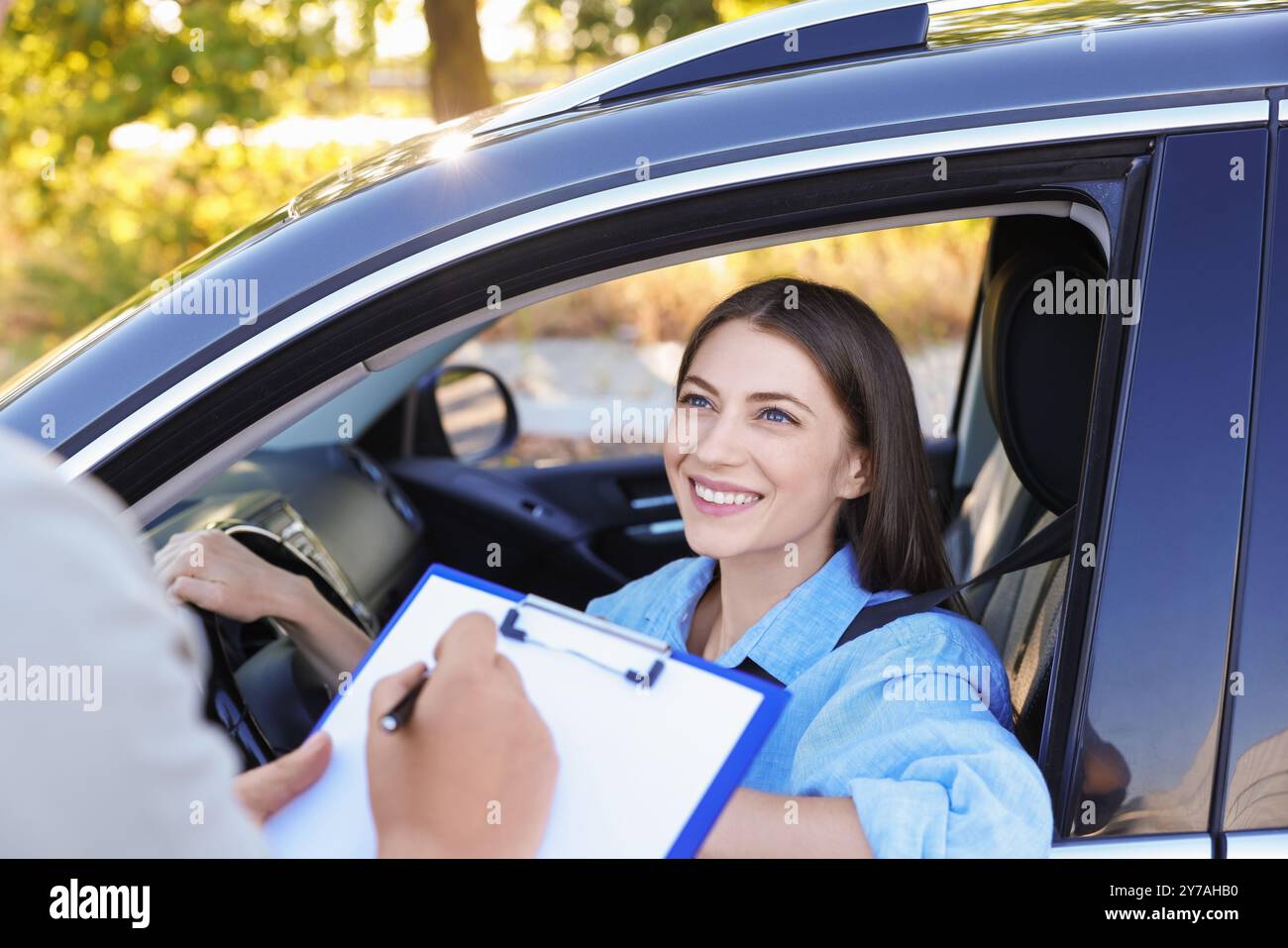 Examiner near car with student during test at driving school Stock ...