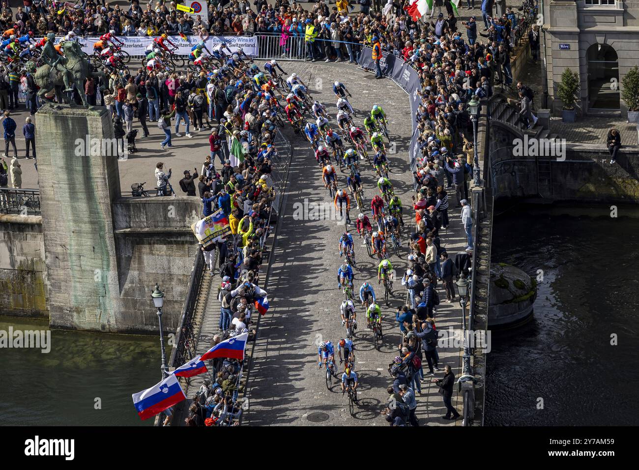 The peloton cross the Muenster bridge over the river Limmat during the ...