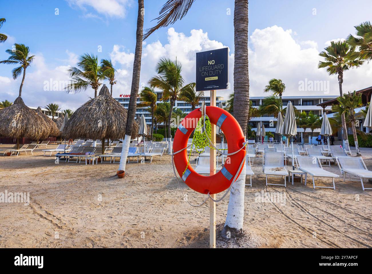 Lifeguard sign with life preserver on sandy beach at resort on Curacao ...
