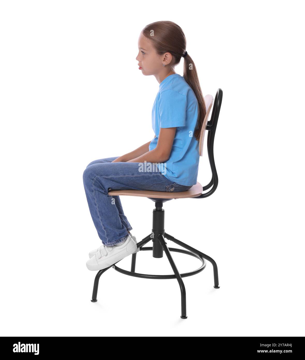 Girl with incorrect posture sitting on chair against white background ...