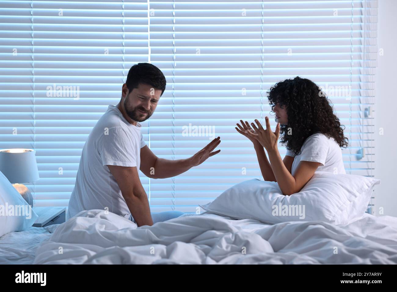 Emotional couple arguing in bedroom at night. Relationship problems ...