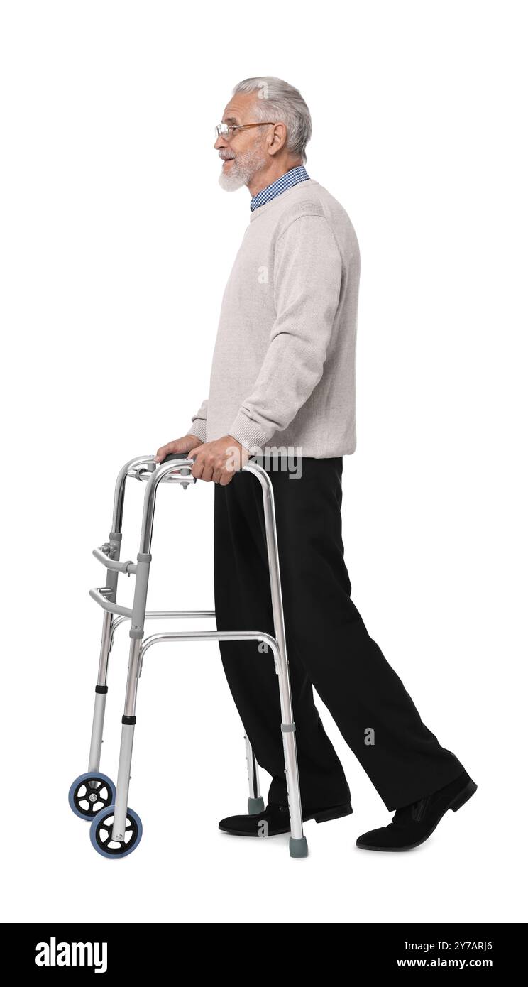 Senior man using walking frame on white background Stock Photo - Alamy