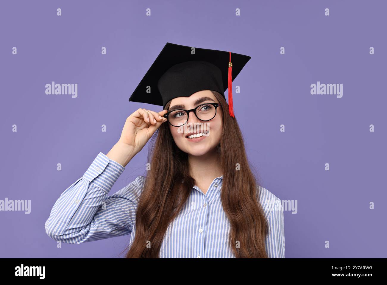 Happy student after graduation on violet background Stock Photo - Alamy
