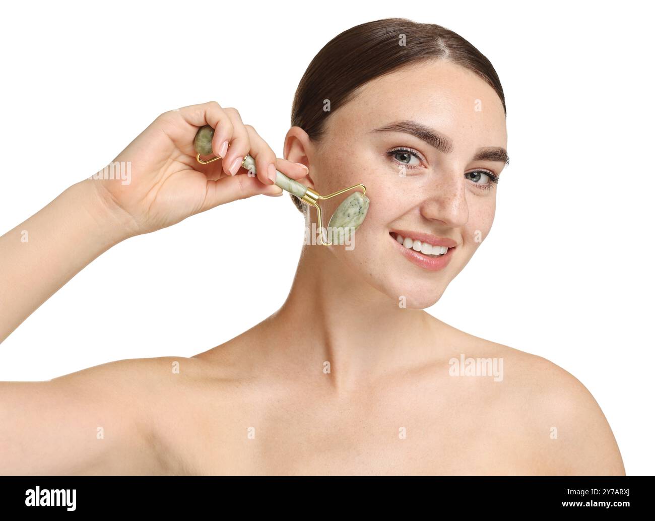Beautiful young woman doing facial massage with roller on white background Stock Photo - Alamy