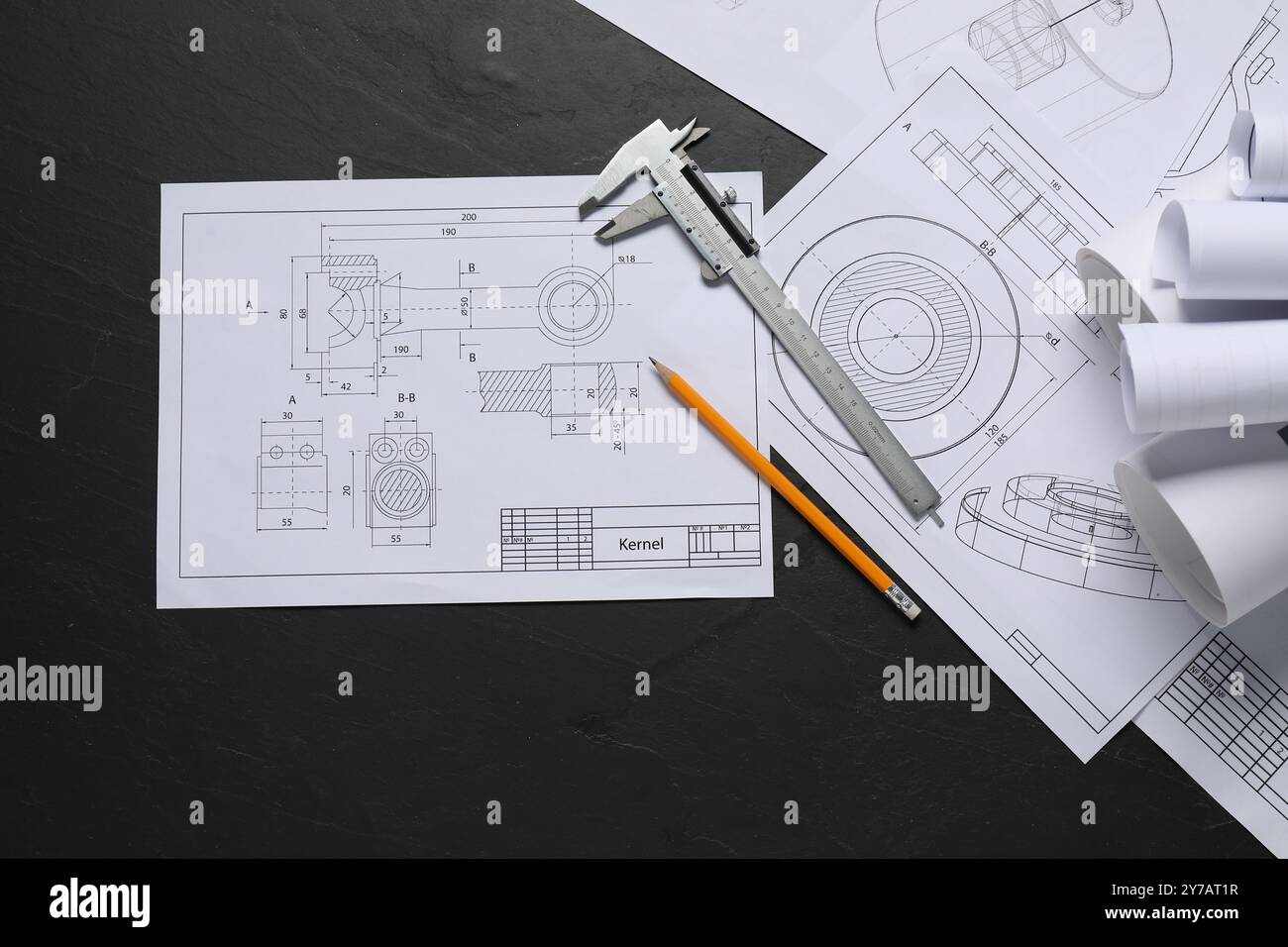 Different engineering drawings, ruler and pencil on grey textured table ...