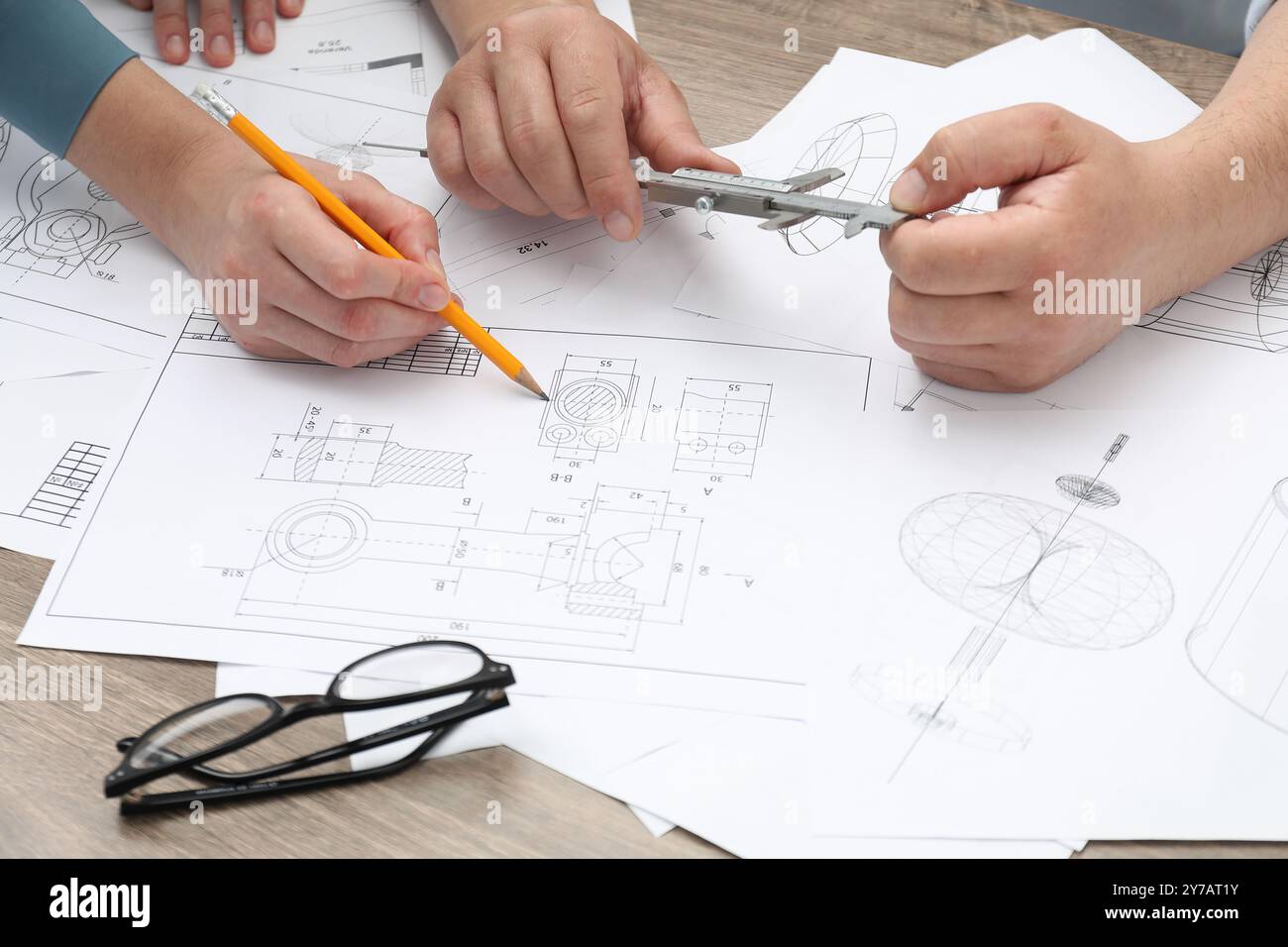 Engineers working with project, closeup. Different technical drawings on wooden table Stock ...