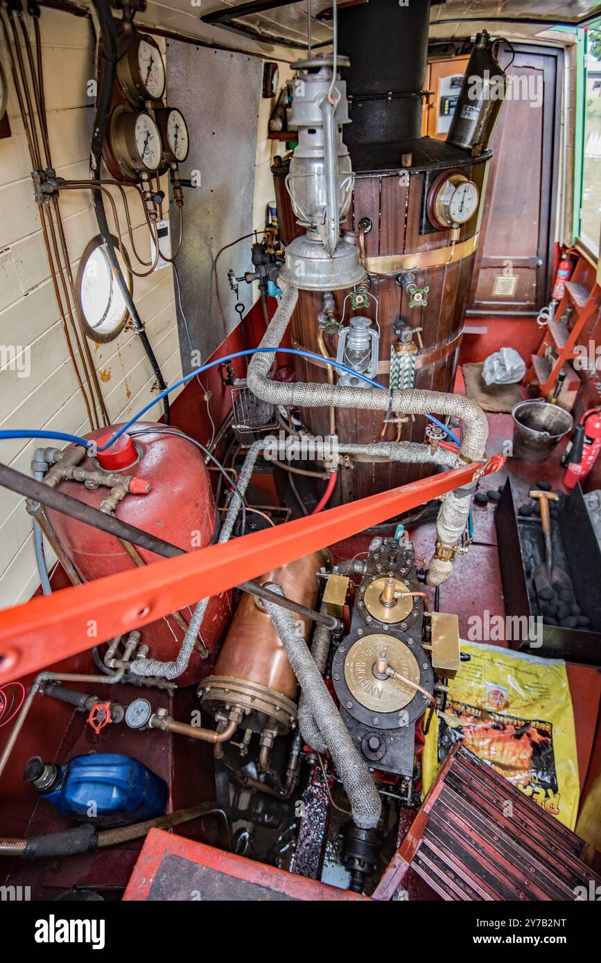 'Tixall', a steam driven narrowboat parked up near the low road bridge ...