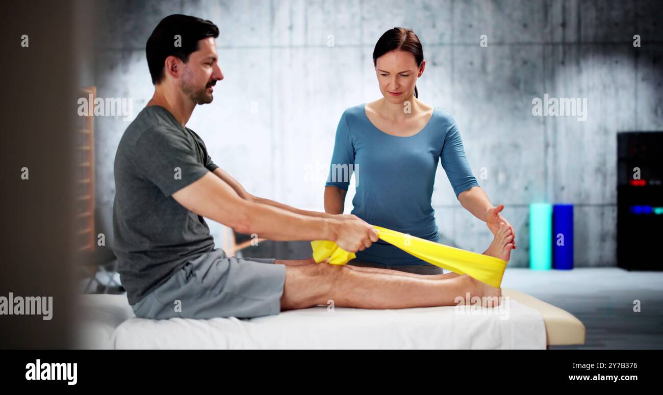Knee Exercise Therapy And Treatment Using Physical Band Stock Photo - Alamy