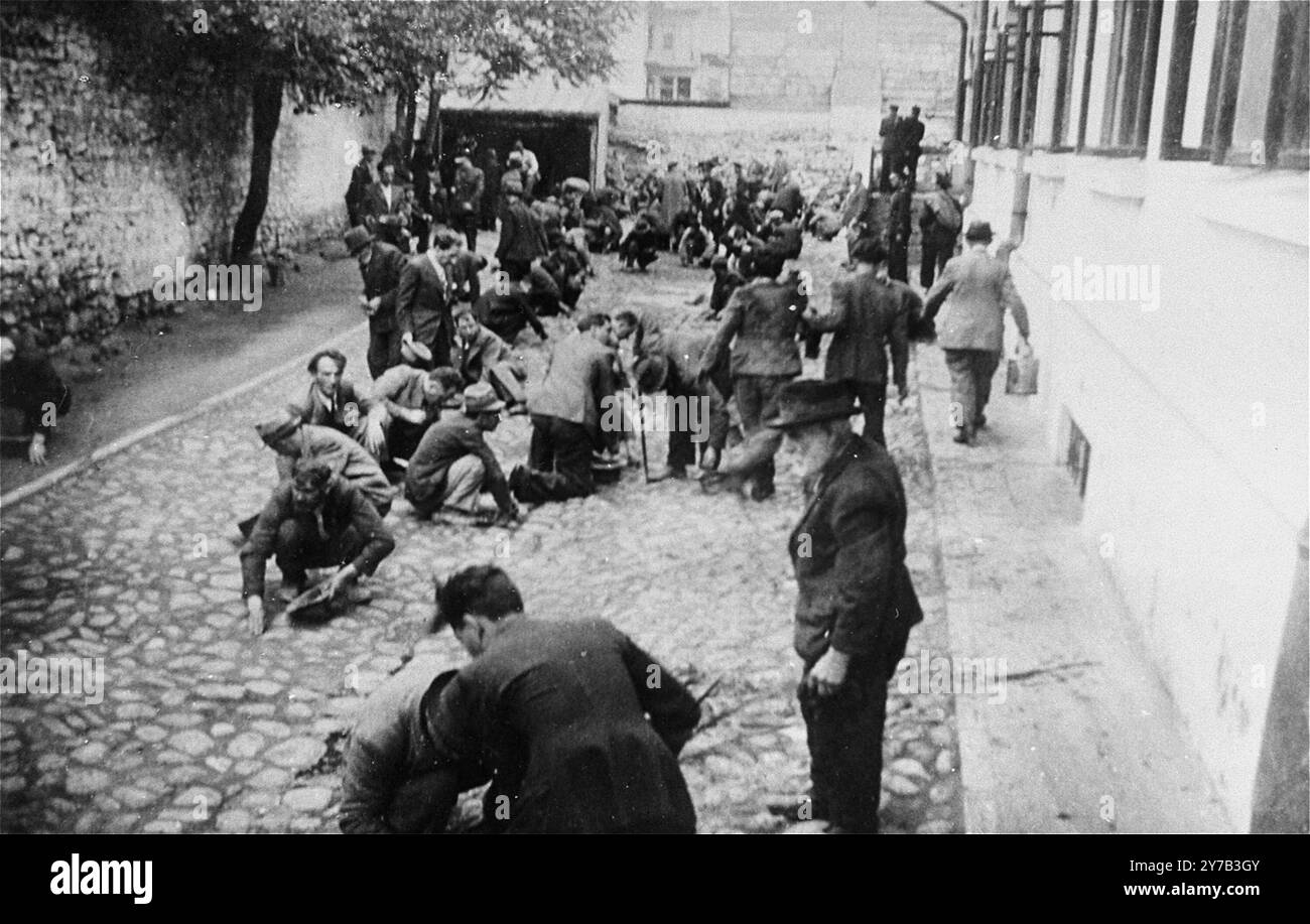 Jews are forced to clean blood from the cobblestone pavement of the ...