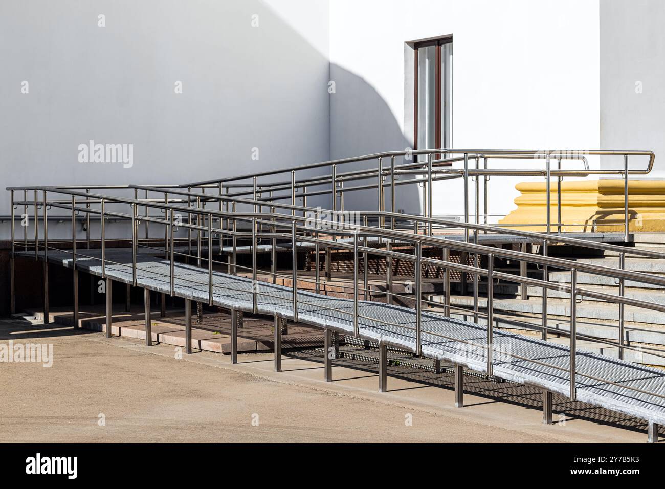a long metal ramp leading to the entrance of the building. a ramp ...