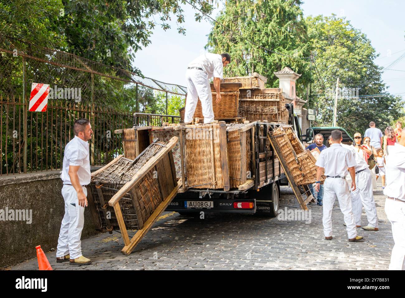 Wicker basket runners on the Portuguese Island of Madeira unloading ...