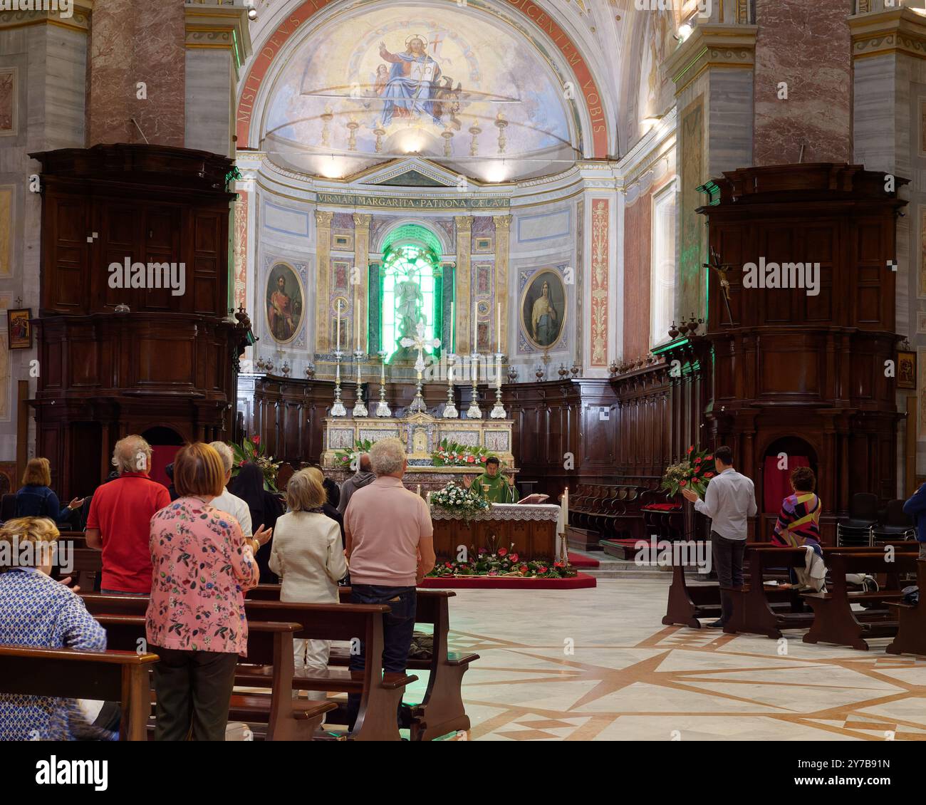 Congregation with altar and priest inside the Basilica di Santa ...