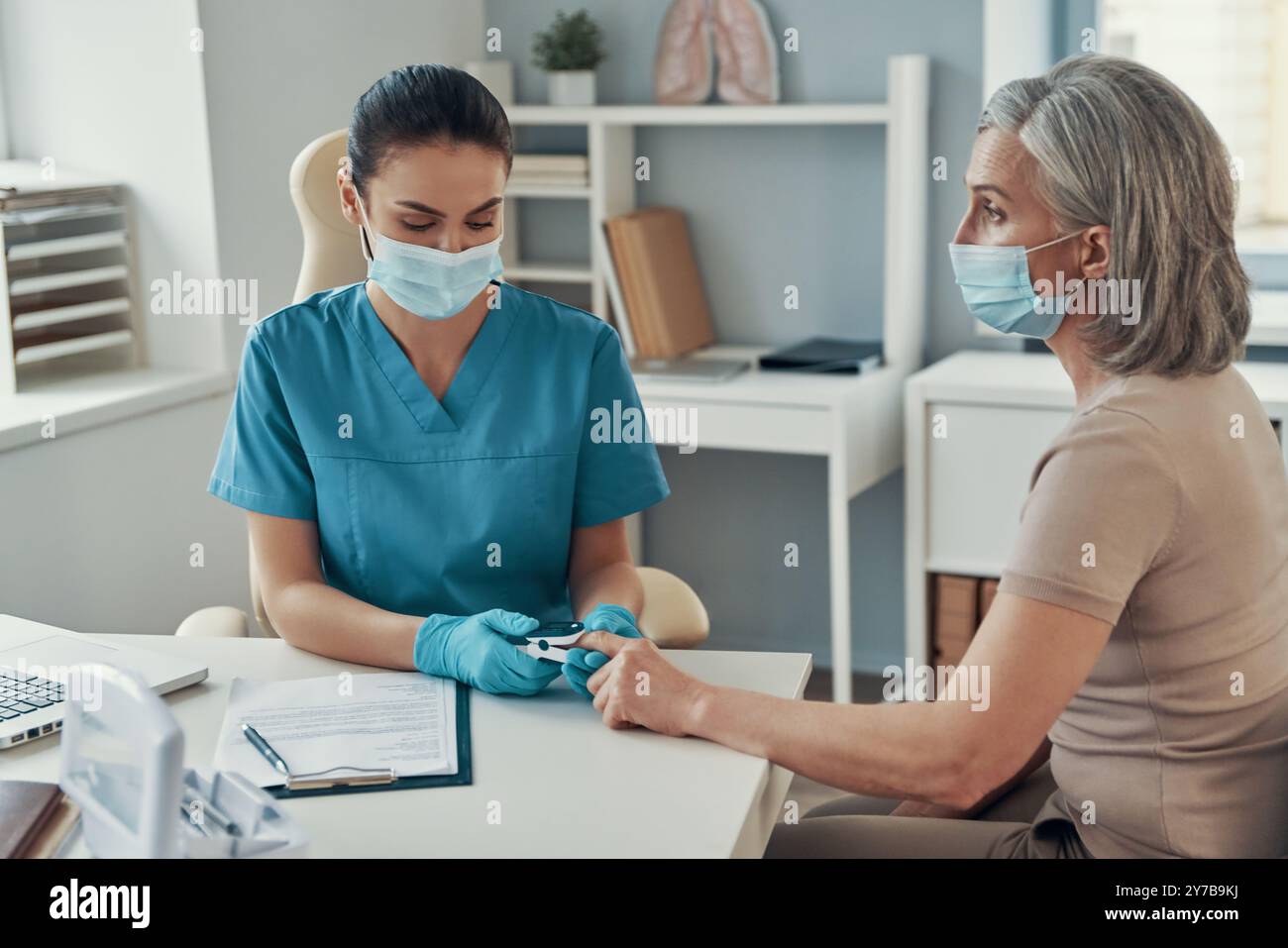 Young female nurse using monitoring hi-res stock photography and images ...