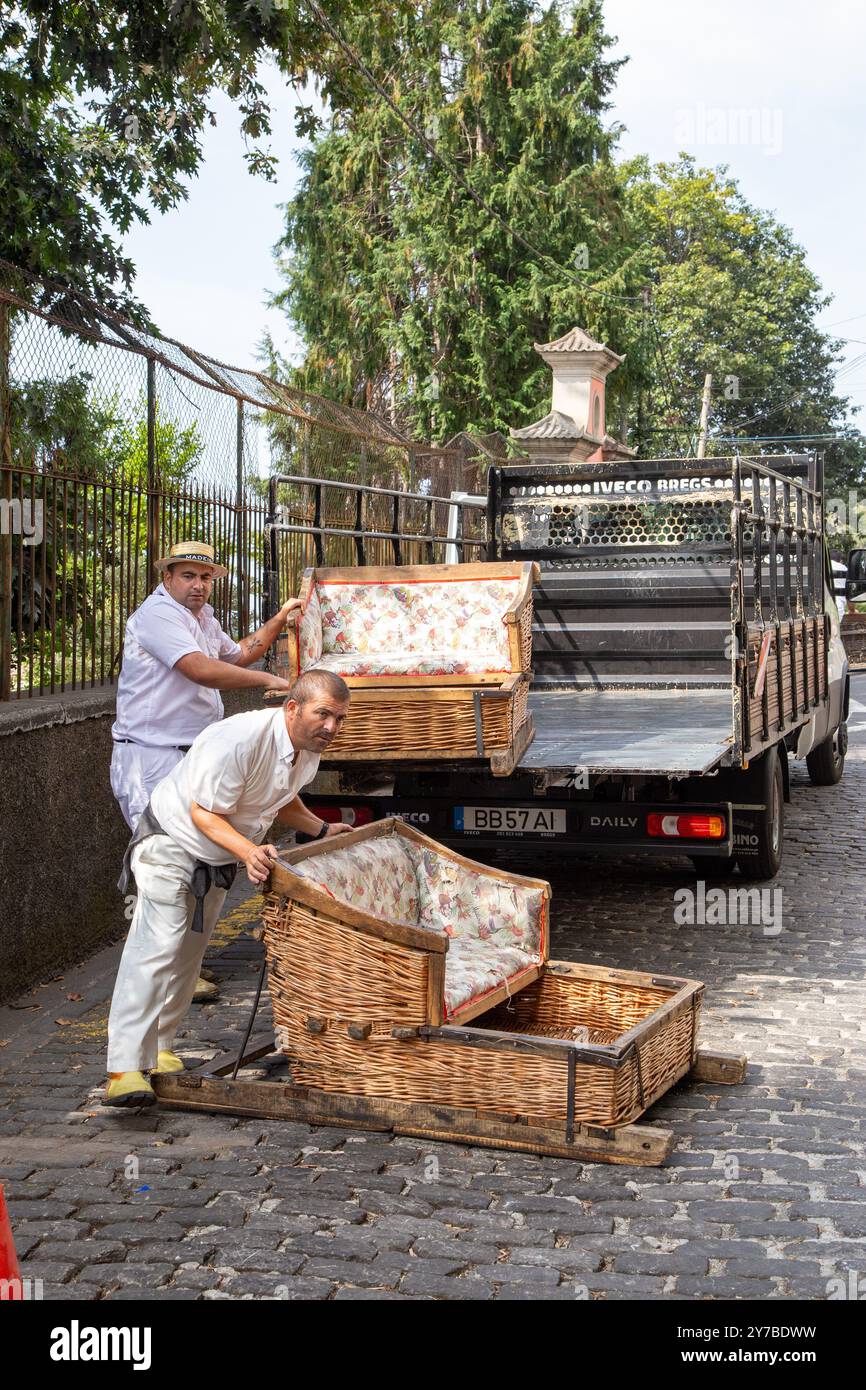 Unloading wicker sledges from a wagon ready for tourists to ride the ...