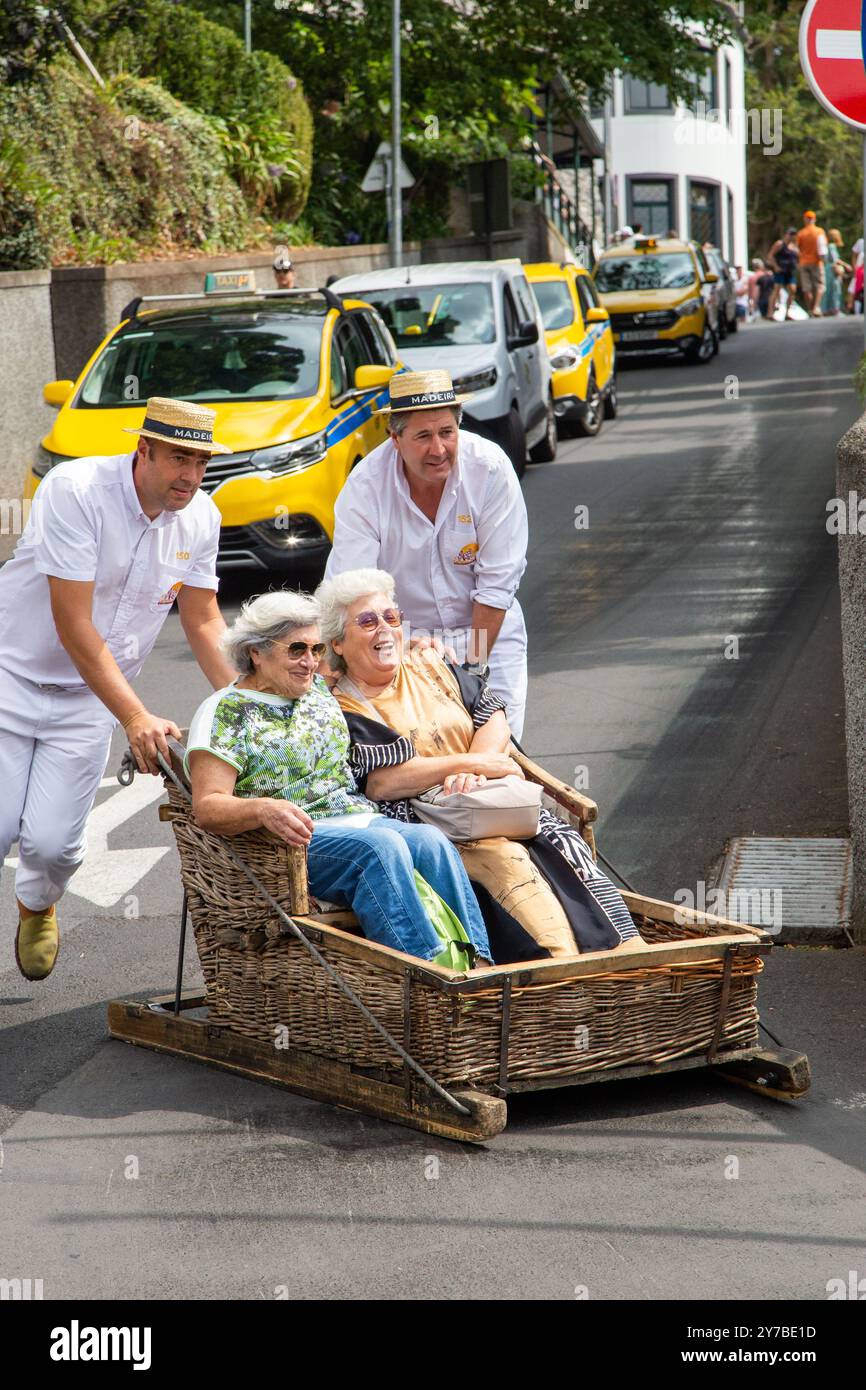 Holidaymakers and tourists having fun taking a ride in traditional ...