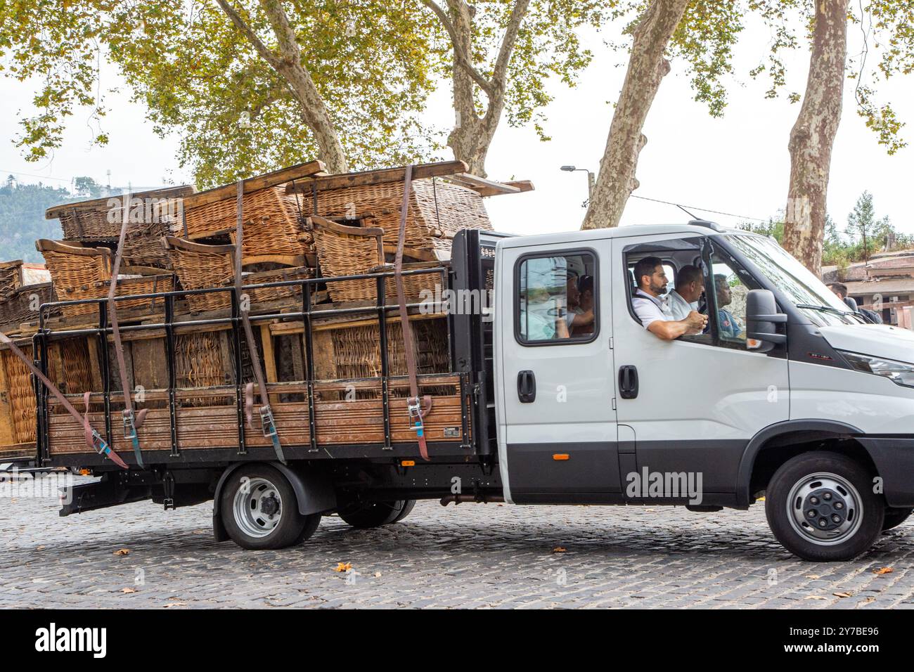 Wicker basket runners on the Portuguese Island of Madeira unloading ...