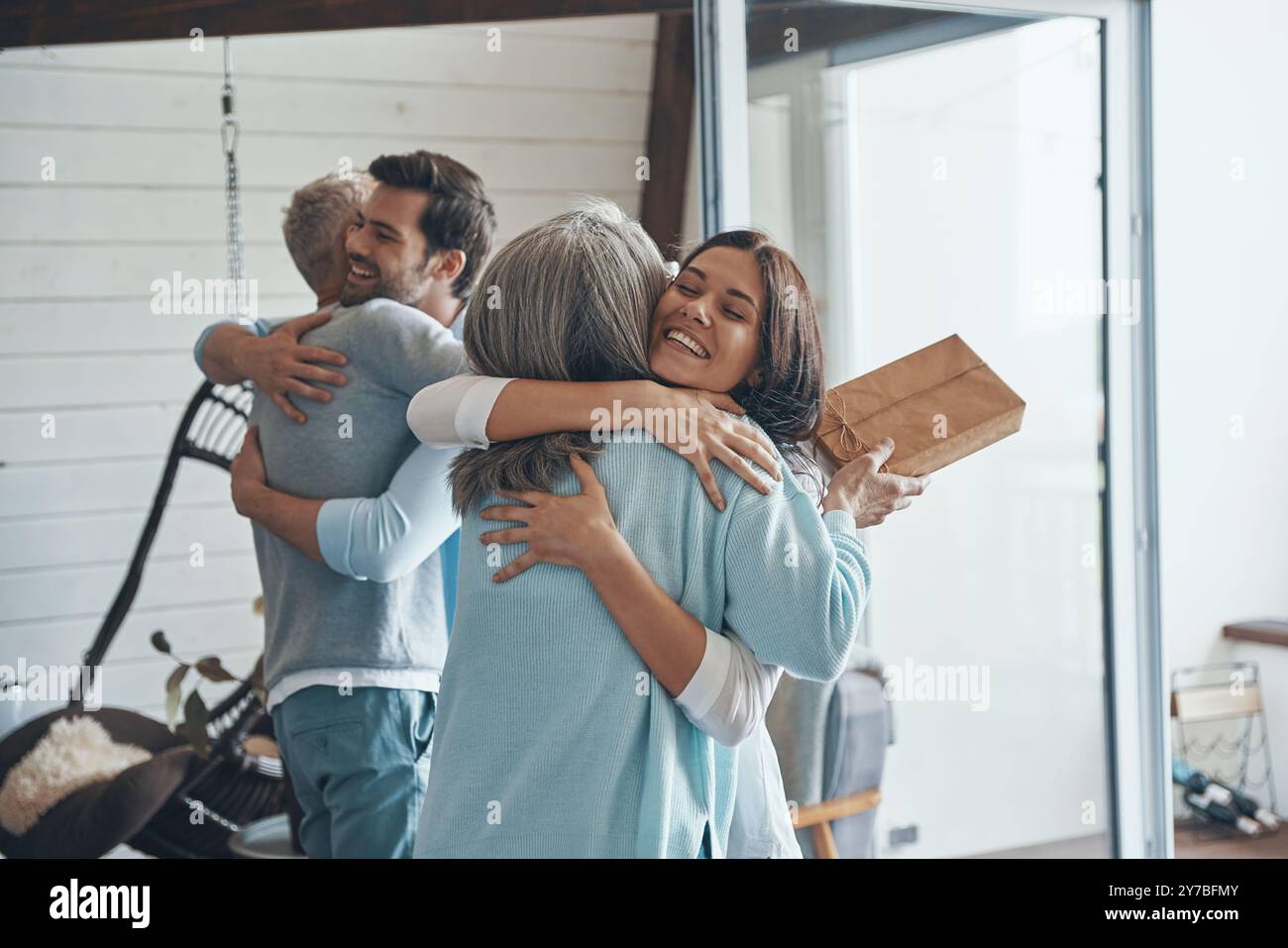 Happy senior parents meeting young couple inside the house Stock Photo ...