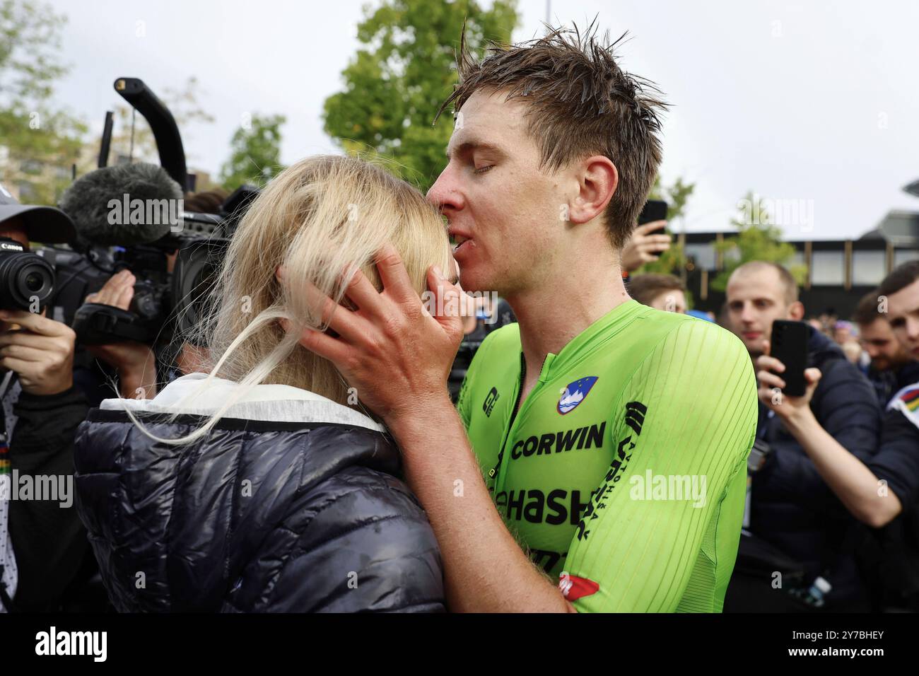 Slovenia's Tadej Pogacar kisses his girlfriend Urska Zigar after winning the Men Elite road race ...