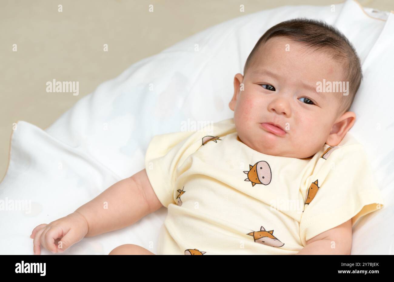 Asian infant crying baby. child tired and hungry in mother arms ...