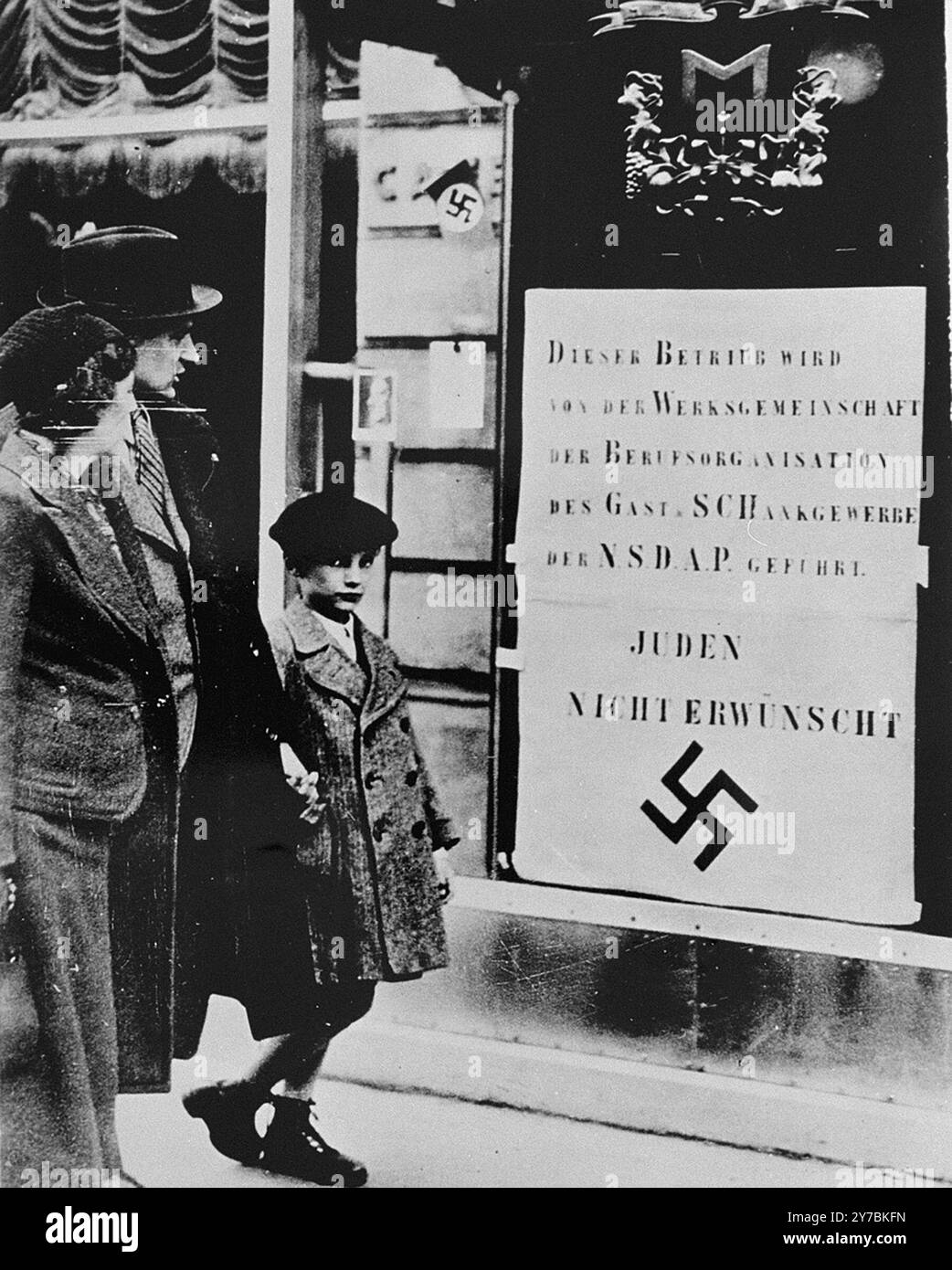 Viennese pedestrians view a large Nazi sign posted on a restaurant ...