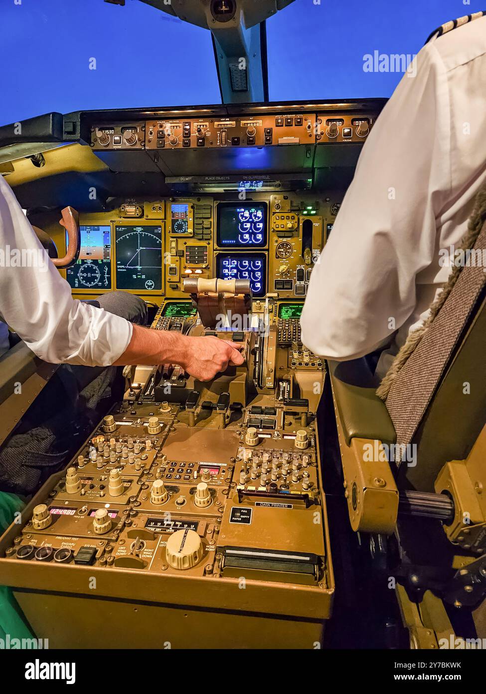 Pilots in a cockpit preparing for takeoff at night. High quality photo ...