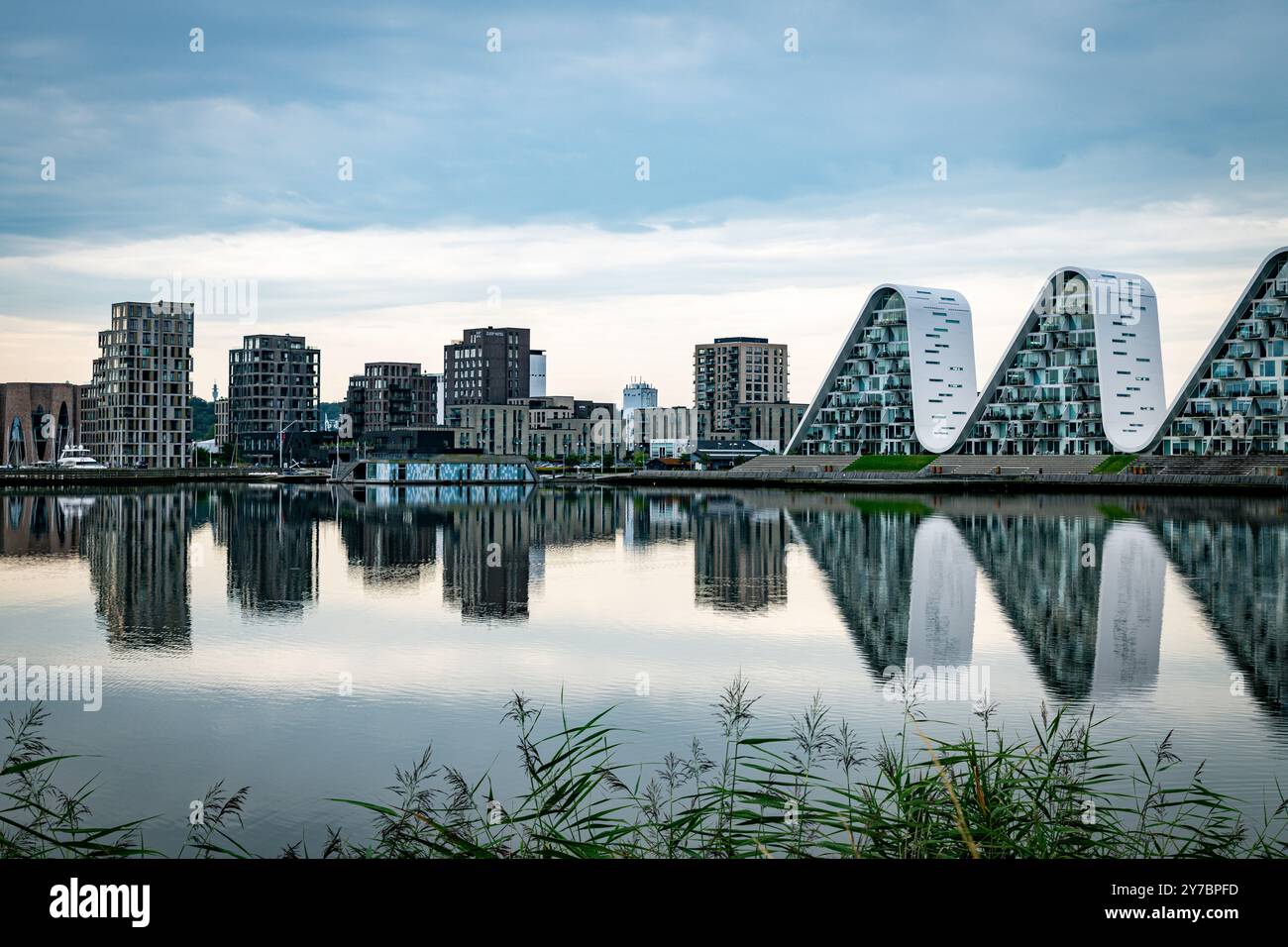 The wave iconic modern apartments in Vejle, Denmark with reflection ...