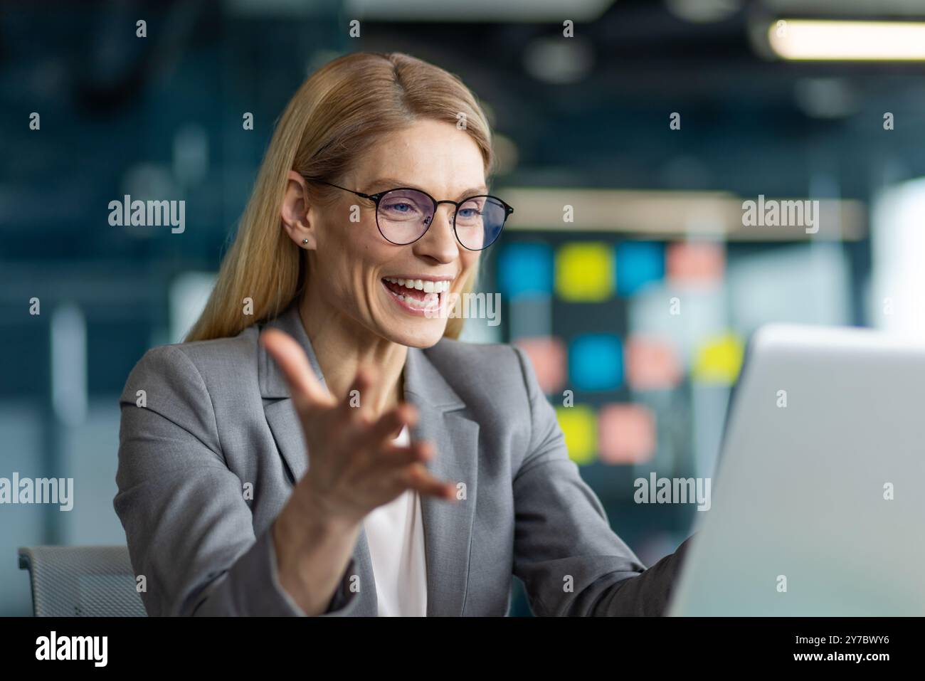 Confident professional woman expressing enthusiasm during virtual ...