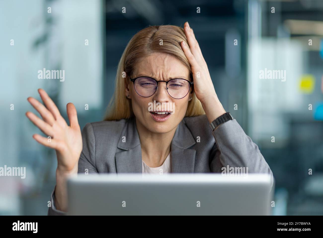 Businesswoman feeling overwhelmed in office shows frustration ...