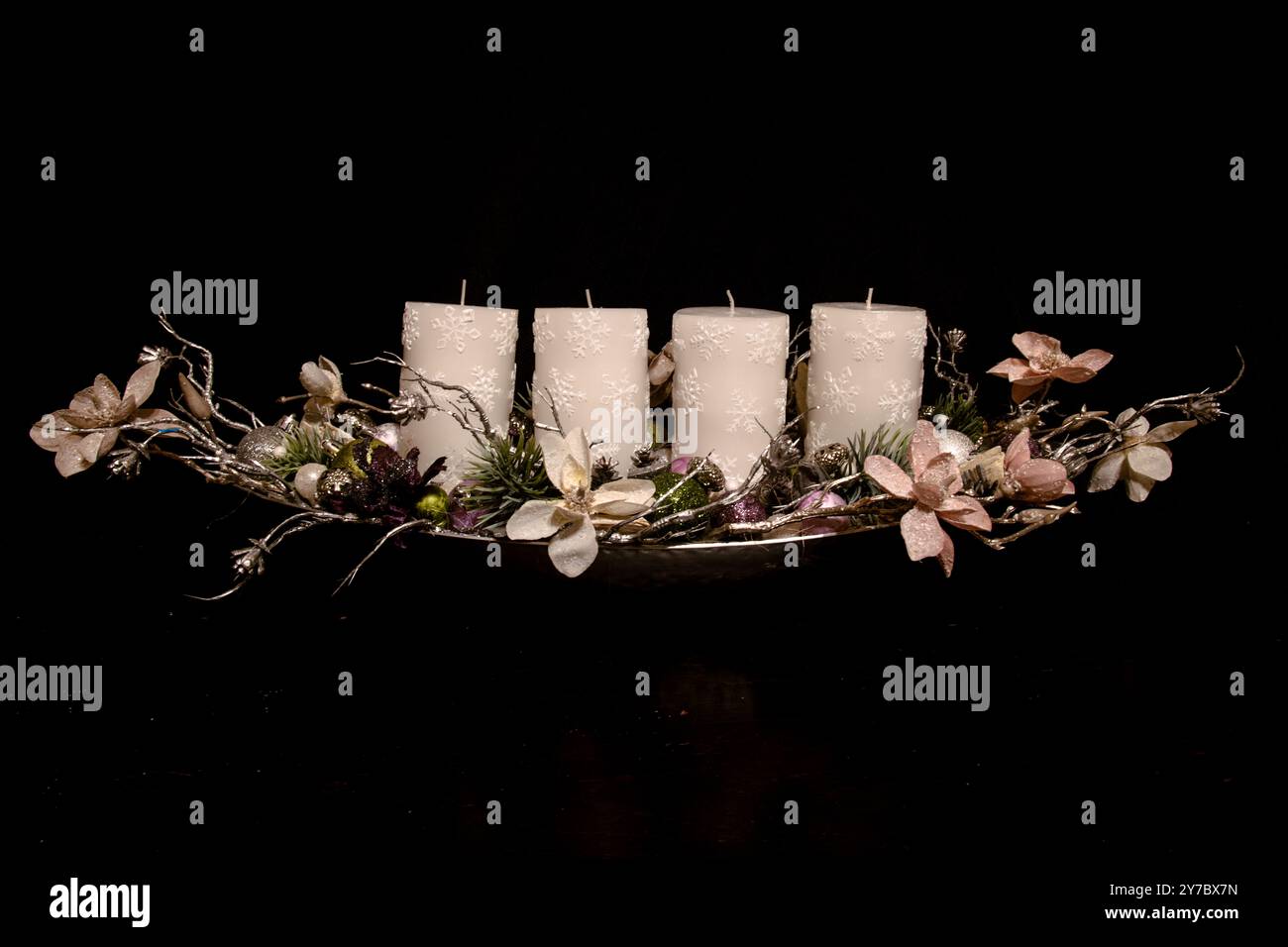 four white advent candles not lit, without flame, on dark background ...