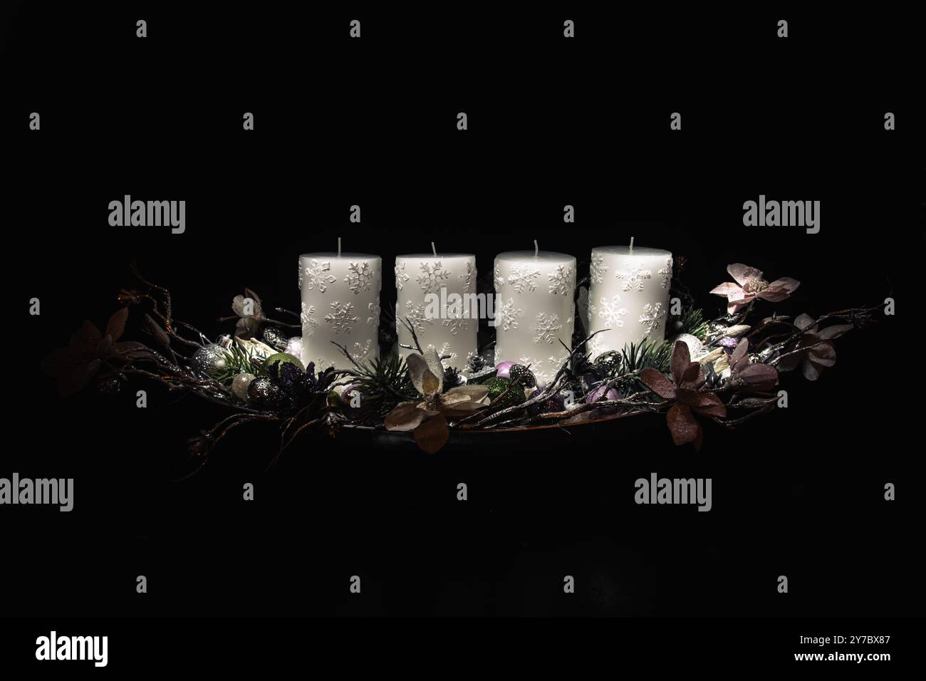 four white advent candles not lit, without flame, on dark background ...