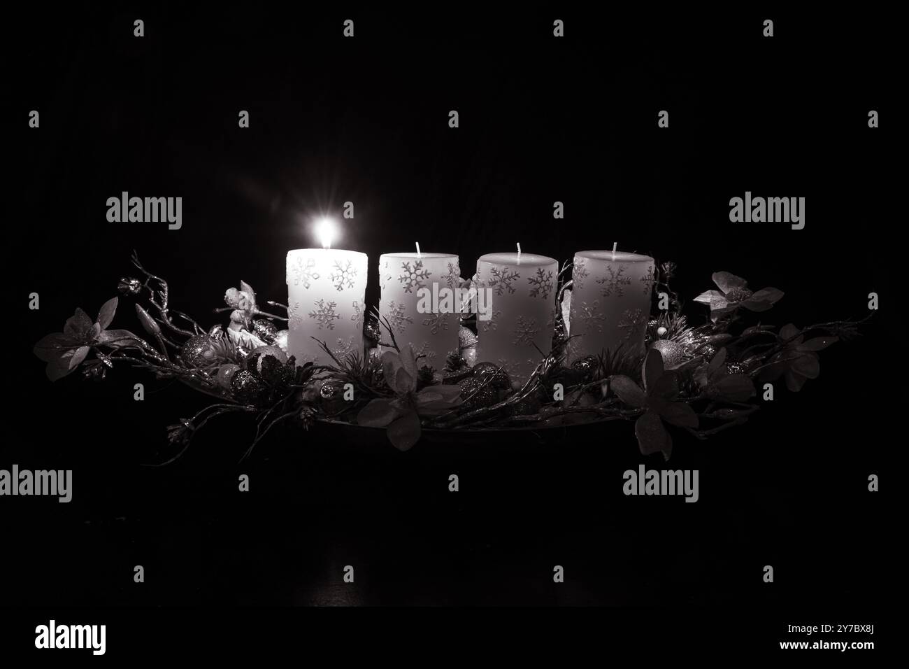 four white advent candles , first advent candle with light, dark black ...