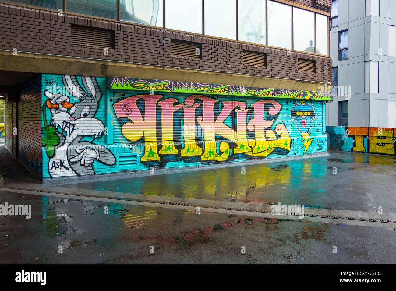 street art graffiti tags wall painting with bugs bunny cartoon in ...