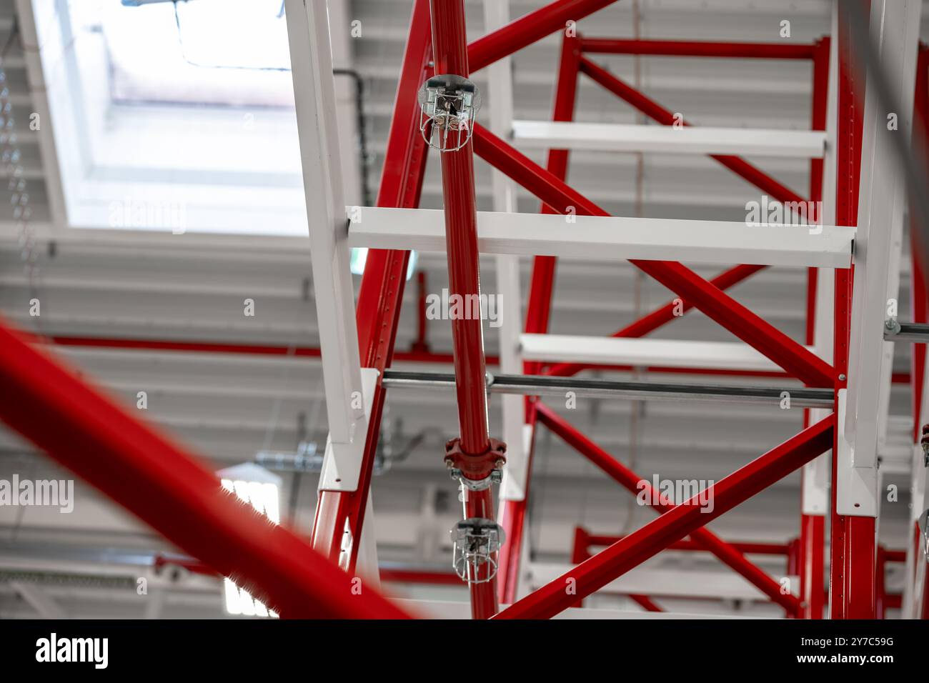 Close up photograph of sprinkler system head inside warehouse racking ...