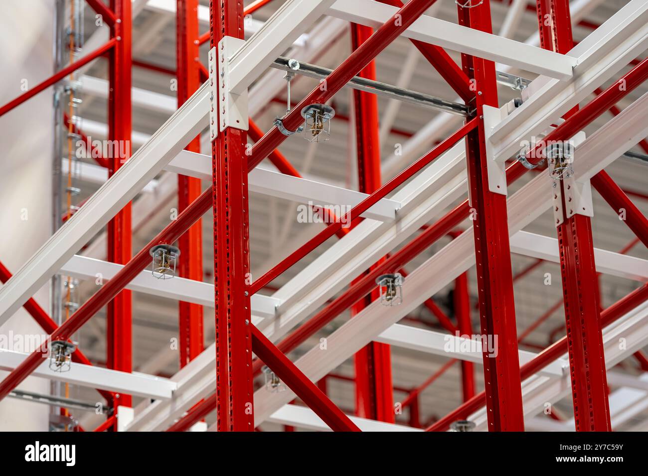 Close up photograph of sprinkler system head inside warehouse racking ...