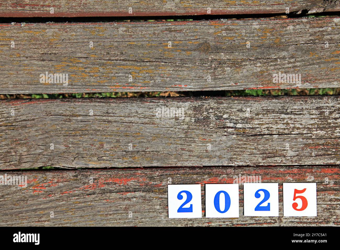 Numbers of 2025 year. Paper square numbers on the wooden background ...