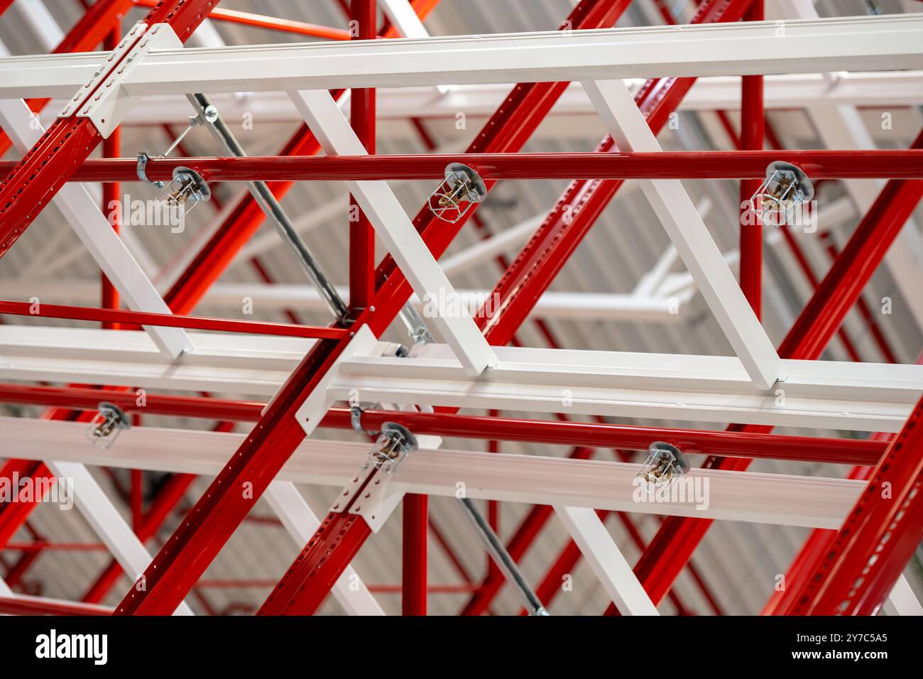 Close up photograph of sprinkler system head inside warehouse racking ...