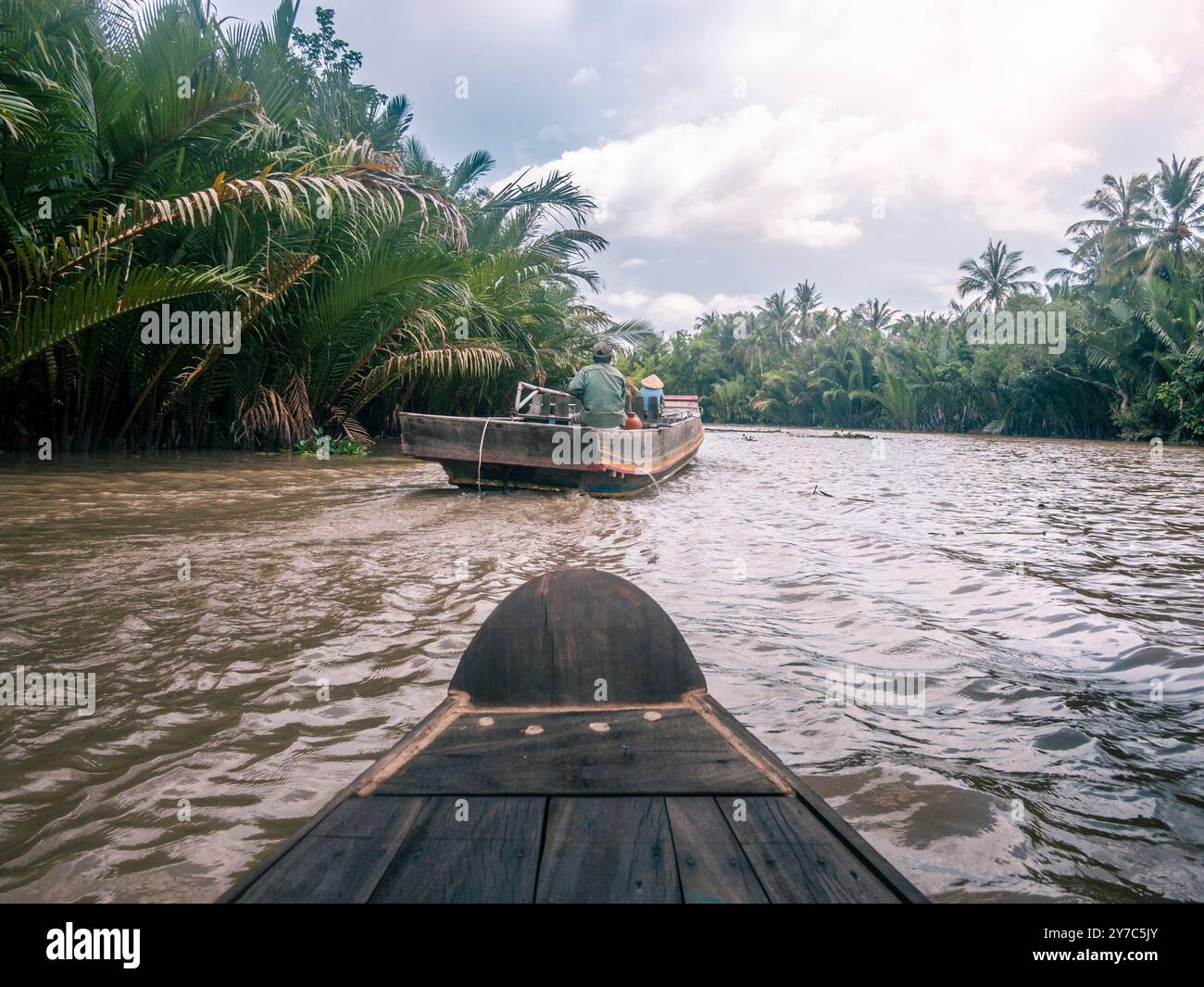Small paddle boats and sampans in the narrow water canals in Ben Tre in ...