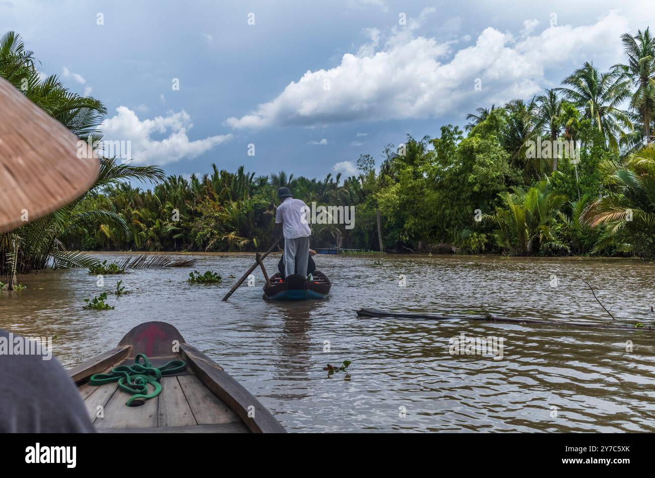 Small paddle boats and sampans in the narrow water canals in Ben Tre in ...
