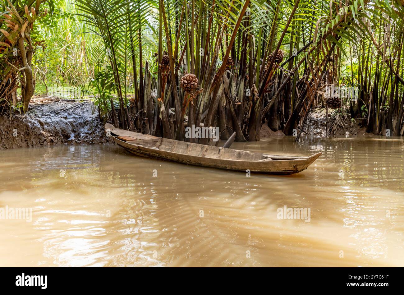 Small paddle boats and sampans in the narrow water canals in Ben Tre in ...