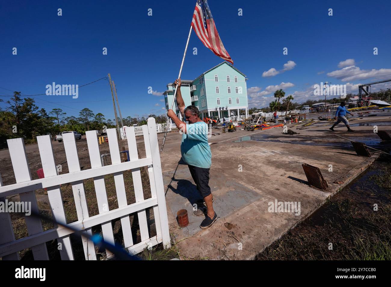 Daniel Dickert plants an American flag on his property were his boat ...