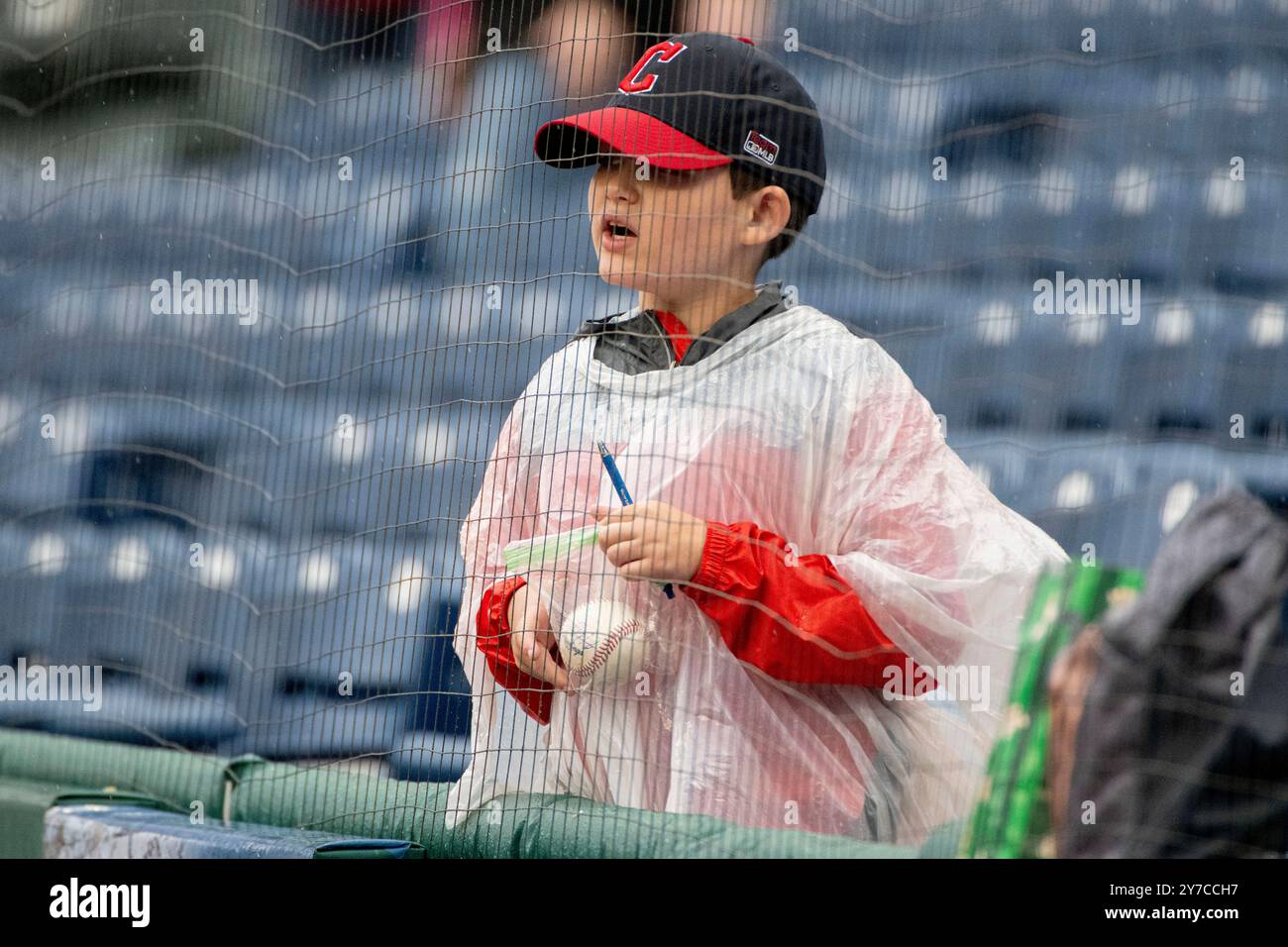 Max Simkin, 10, of Cleveland, waits in the rain for an autograph before ...