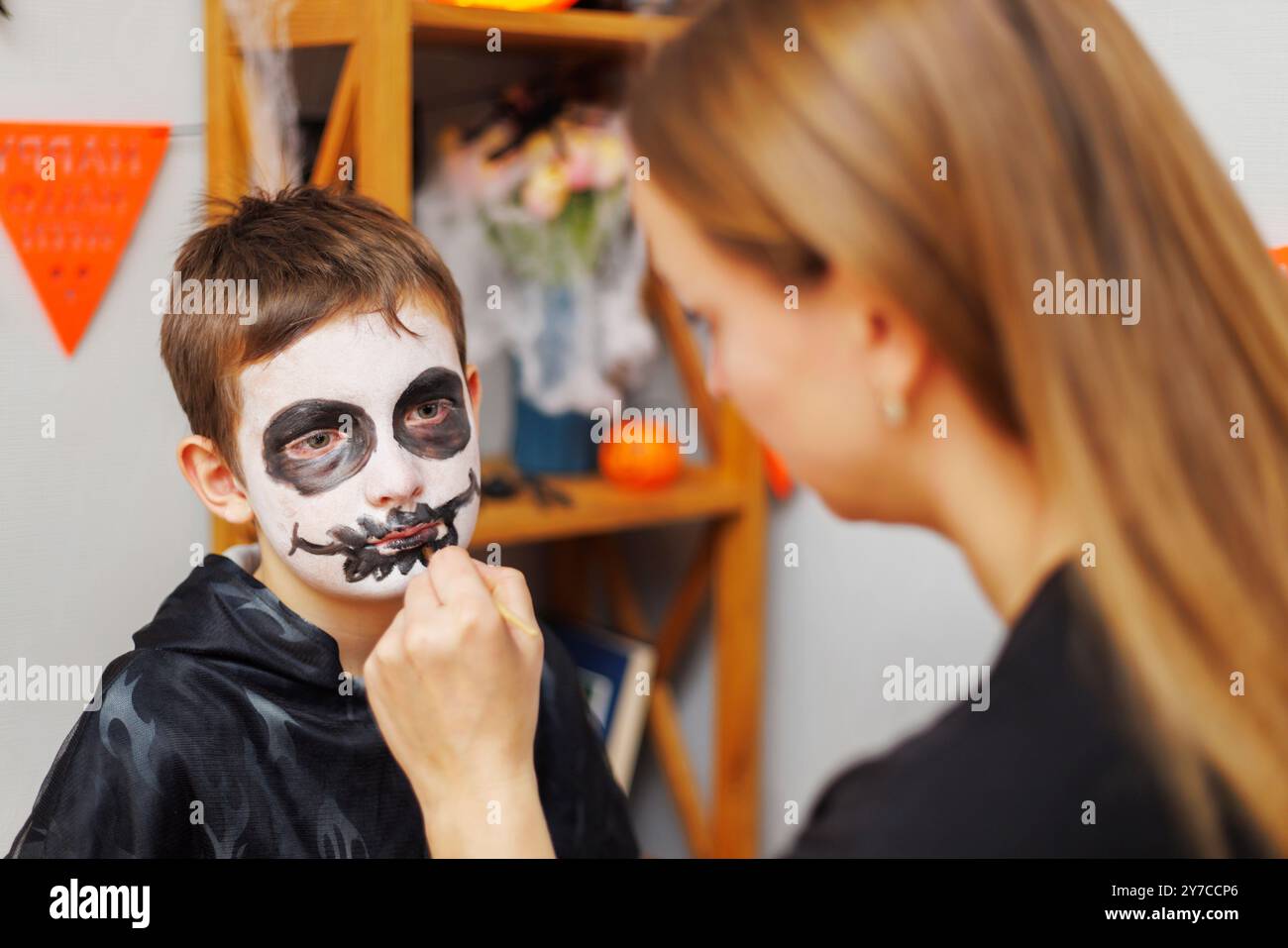 Boy getting face painted for Halloween Stock Photo - Alamy