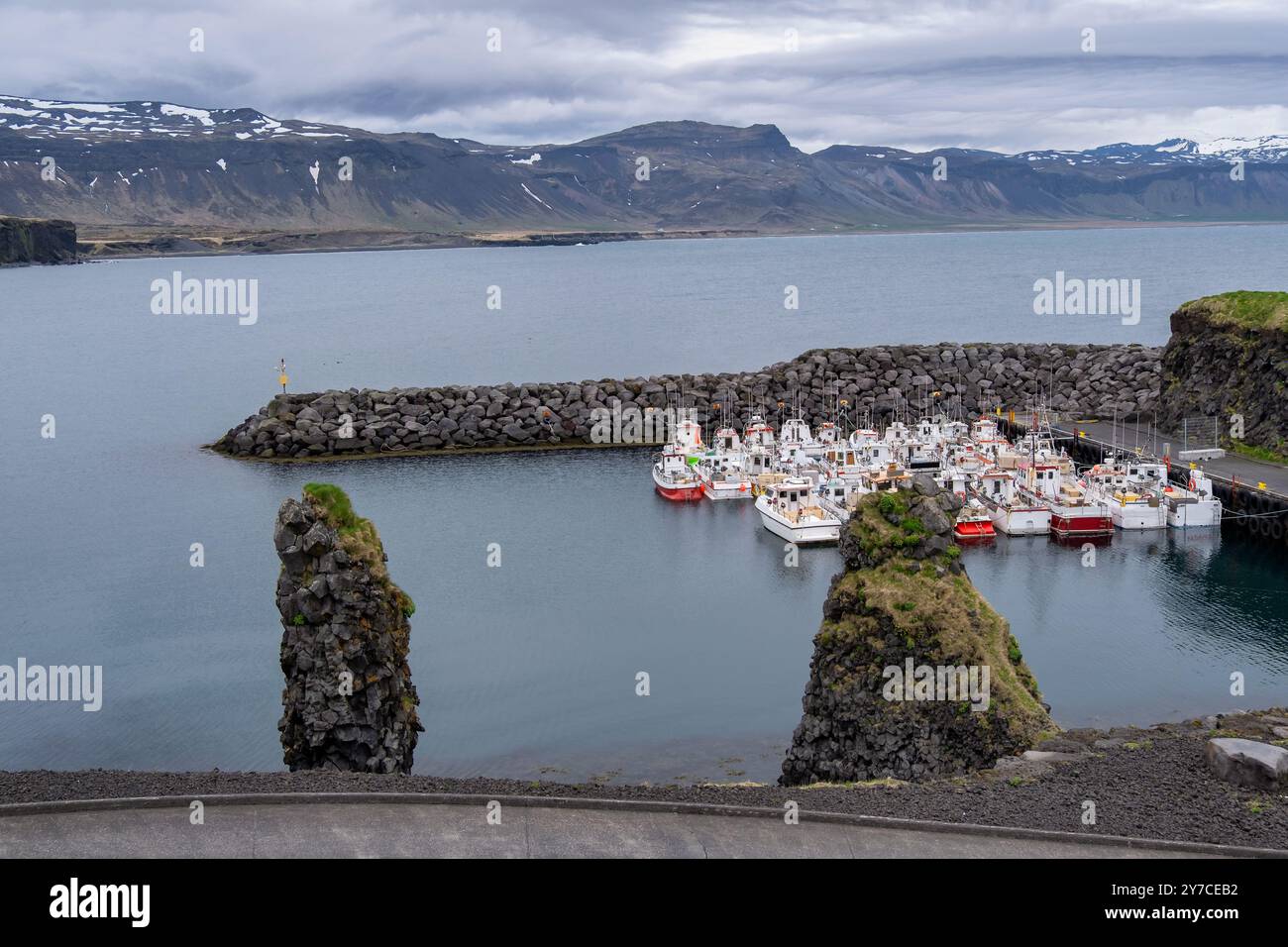 Serene Coastal Harbor with Fishing Boats Docked Along Stone Pier on an ...