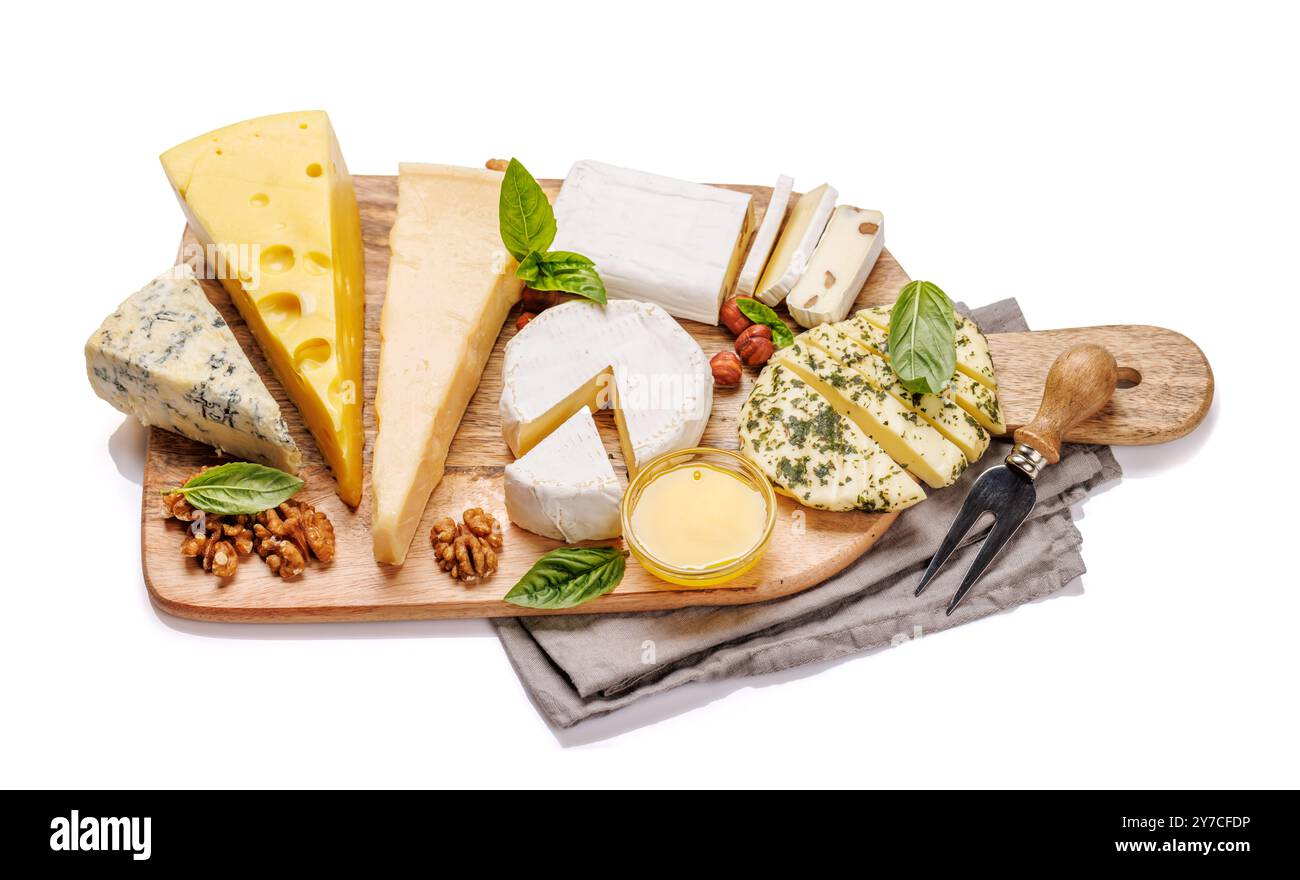 An assortment of various cheeses arranged on a board, highlighting ...