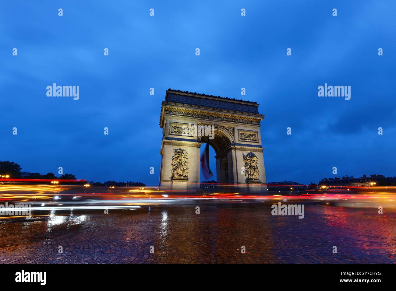 The Triumphal Arch in rainy evening. It is one of the most famous ...