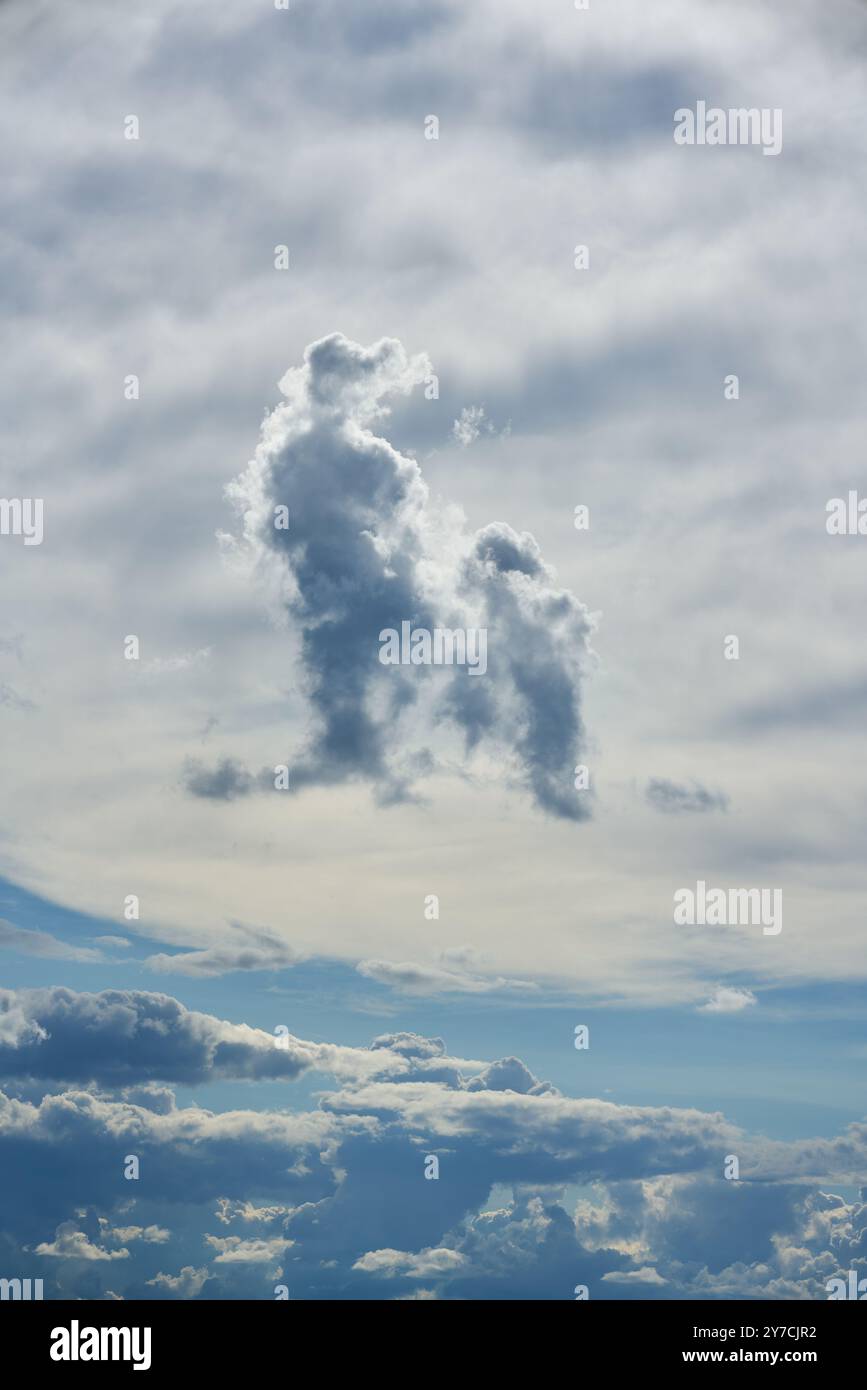 White forms and symbolic clouds on a blue sky Stock Photo - Alamy