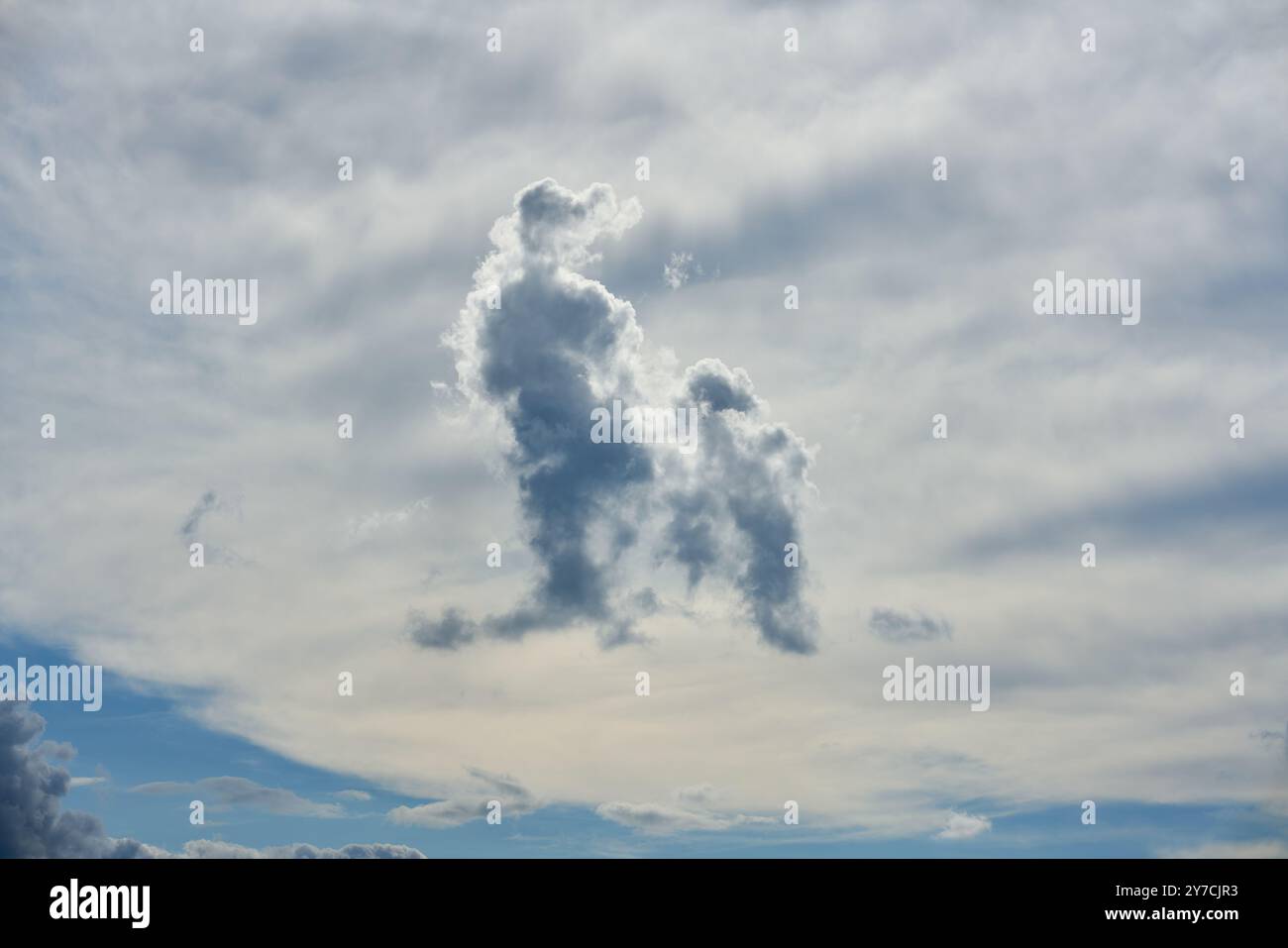 White forms and symbolic clouds on a blue sky Stock Photo - Alamy