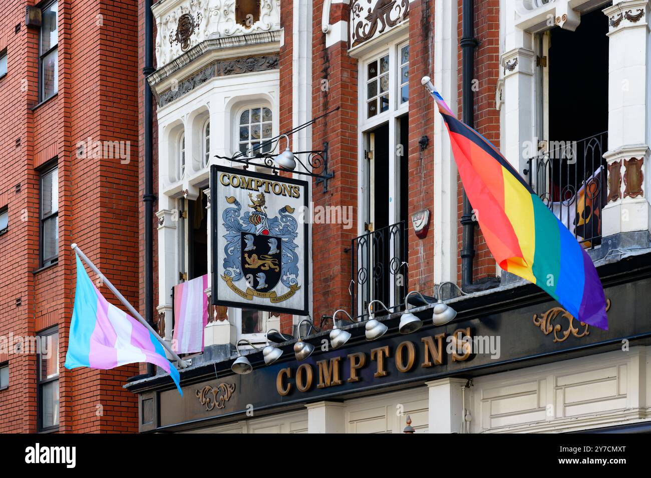 Pub sign of Comptons, and rainbow flag Old Compton Street, in Soho ...