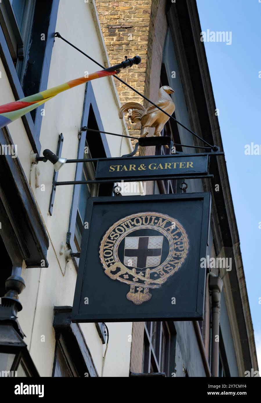Pub sign of the Star & Garter and rainbow flag in Soho London, England ...