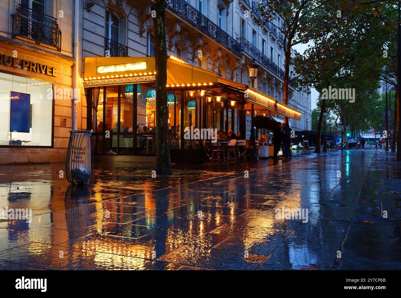 The traditional French cafe de Paris at rainy evening . It located near ...